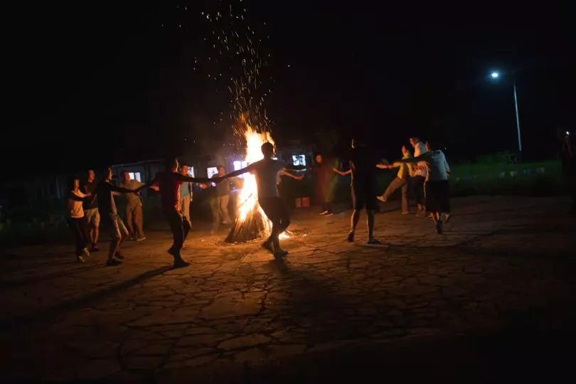 Provincie Heilongjiang, srpen 2017 Hostující univerzitní profesoři z Charbinu se účastní rituálu ohně, který předvádějí místní oroqenští podnikatelé. V současné Číně roste zájem o etnograficky zaměřený turistický průmysl a lidové rituály.