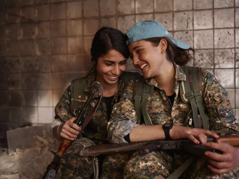 Silava and Berivan share a laugh in an abandoned ISIS base. Shengal, Nineveh Governorate, Iraq, November 23, 2015. From [We Came From Fire ]( https://amzn.to/2L9l8Vm) by Joey L. – published by powerHouse Books