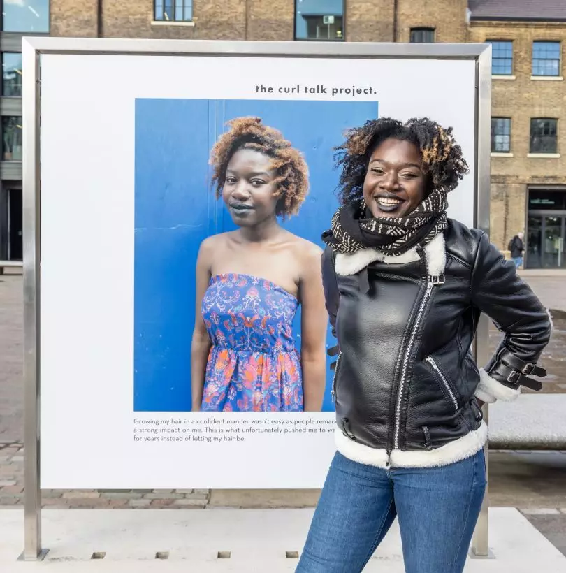 Aude, one of the women to be featured in The Curl Talk Project, stood in front of her own portrait