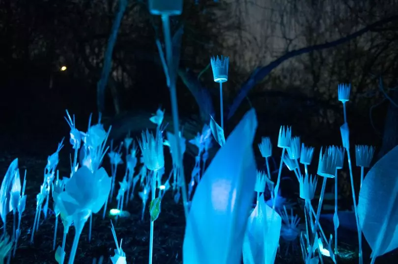 Pflanzen und Blumen, die vollständig aus nicht recycelbarem Müll bestehen, beleuchtet in einem dunklen Wald in Berlin 8590_10